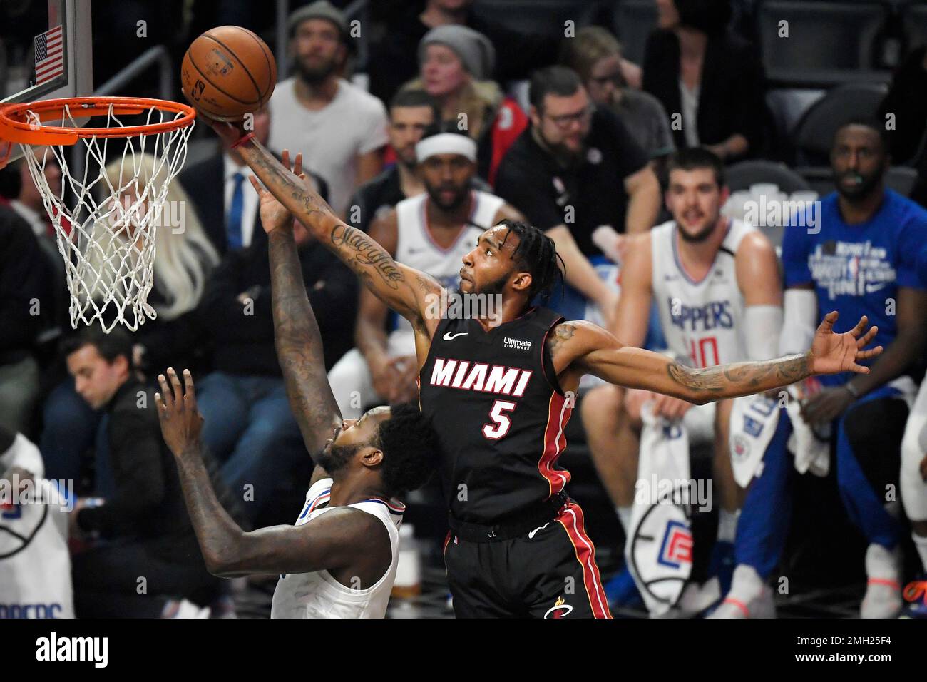 Miami Heat forward Derrick Jones Jr., right, grabs a rebound away from ...