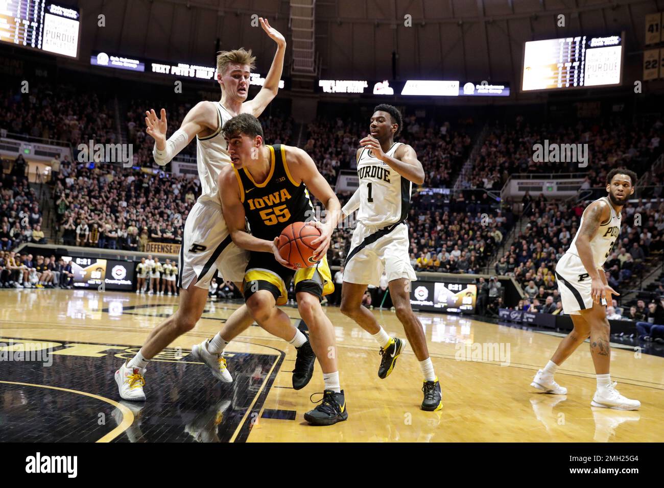 Iowa center Luka Garza (55) drives on Purdue center Matt Haarms (32 ...