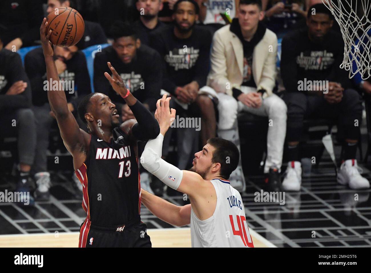 Miami Heat forward Bam Adebayo, left, shoots as Los Angeles Clippers ...