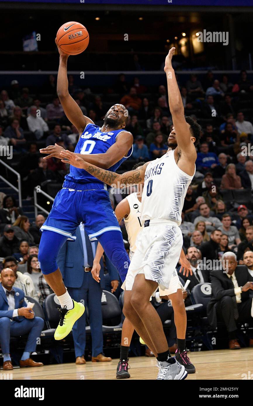 Seton Hall guard Quincy McKnight, left, shoots next to Georgetown guard ...
