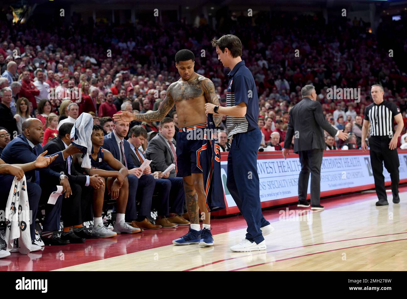 Auburn guard J'Von McCormick puts on a new uniform after is was ripped ...