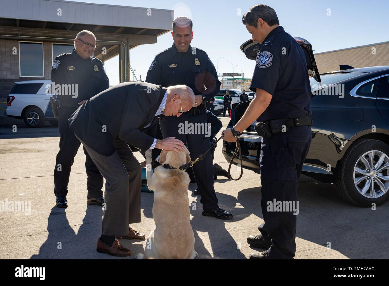 President Joe Biden pets a dog at a demonstration on how border agents ...