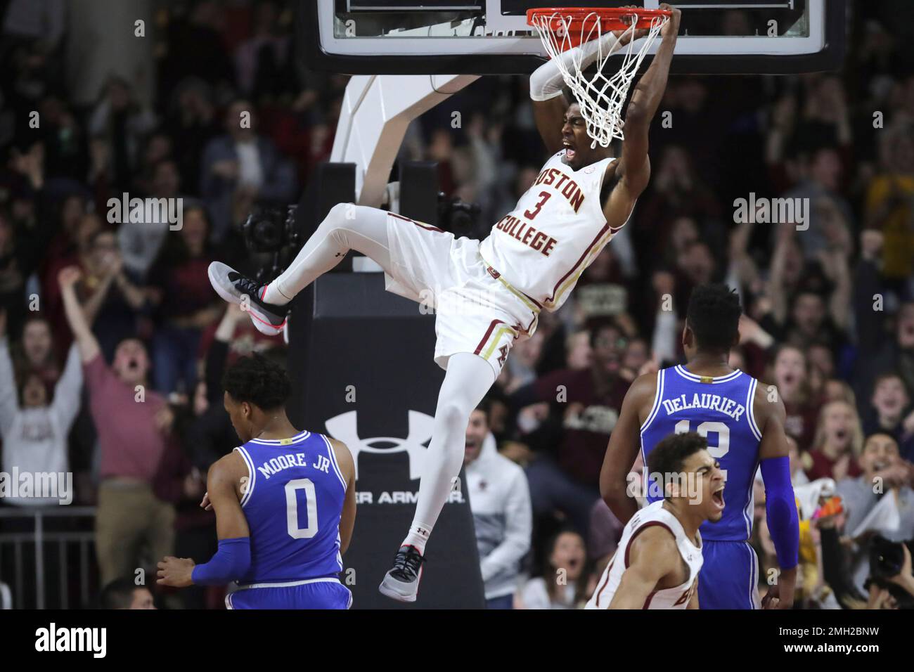Boston College guard Jared Hamilton (3) lets out a scream as he hangs ...