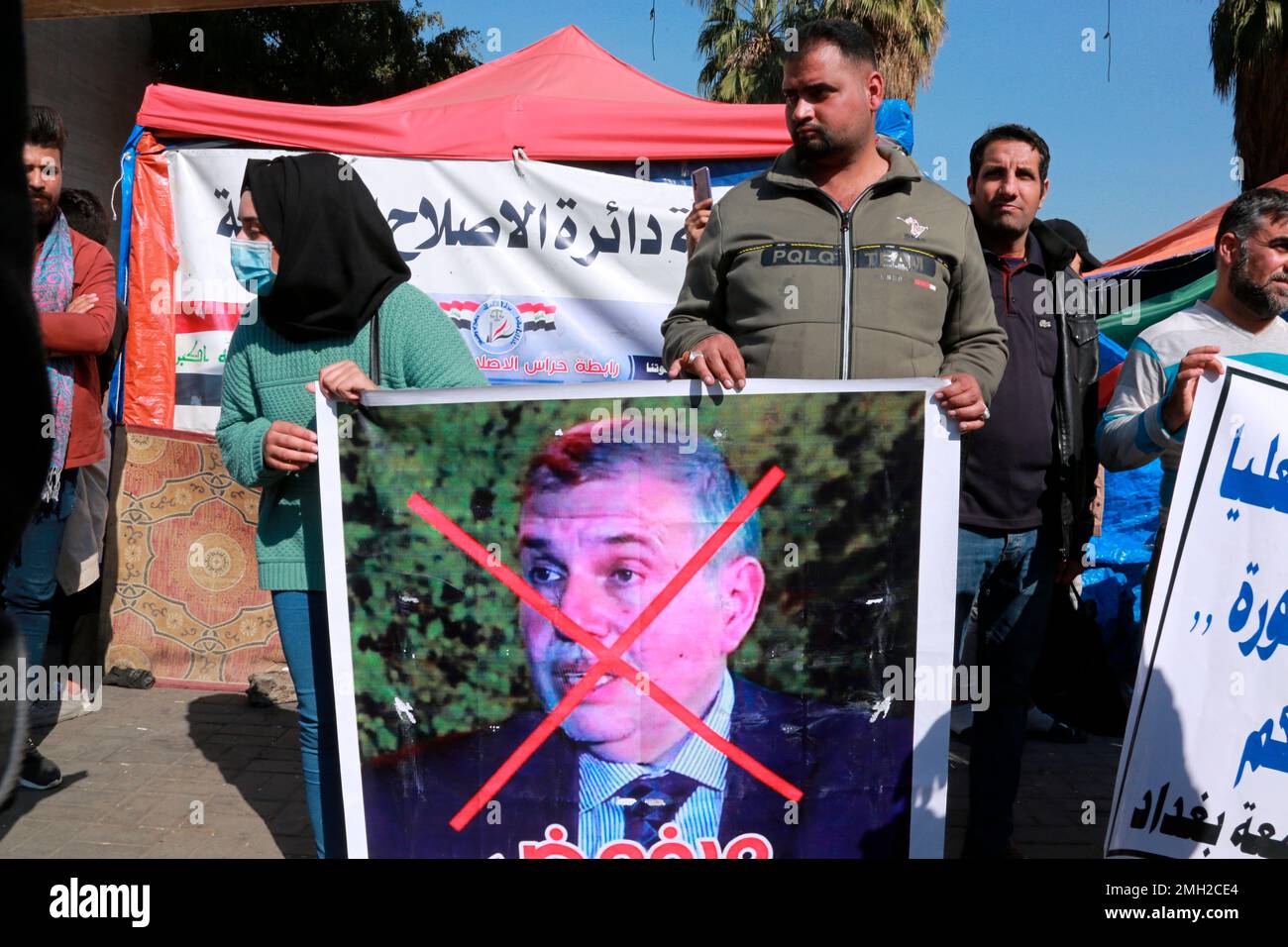 Anti-government protesters hold a poster of newly-appointed Prime ...