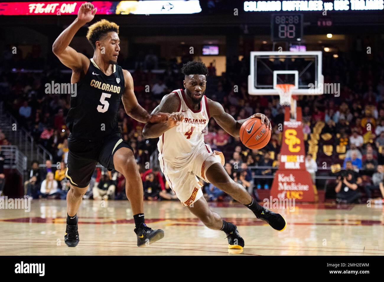 Southern California guard Daniel Utomi, right, drives towards the ...