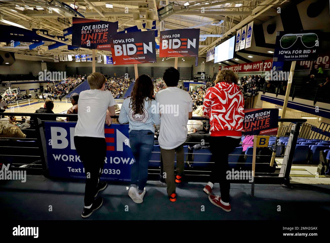 Younger caucus goers hold signs for Democratic presidential candidate ...
