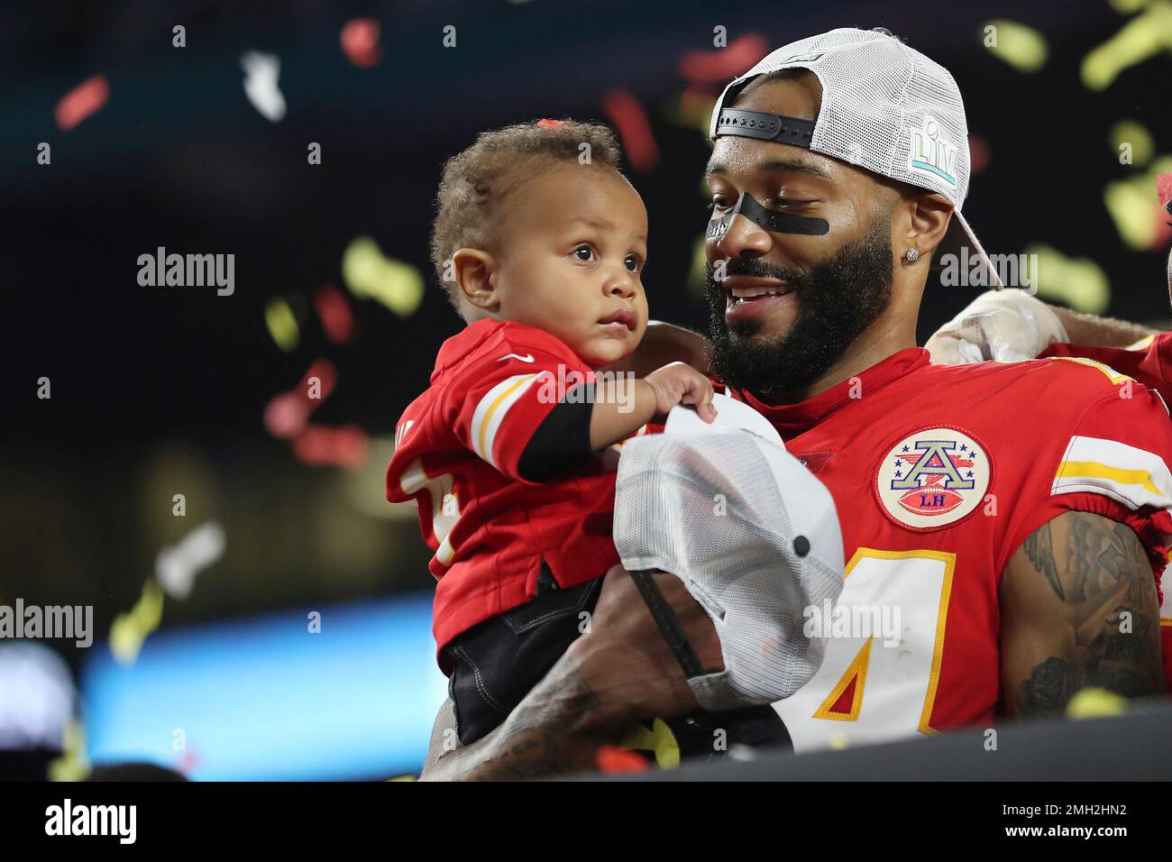 Kansas City Chiefs strong safety Jordan Lucas (24) holds his son Jayce ...