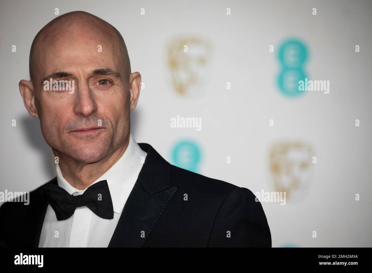 Mark Strong poses for photographers upon arrival at the Bafta Film ...