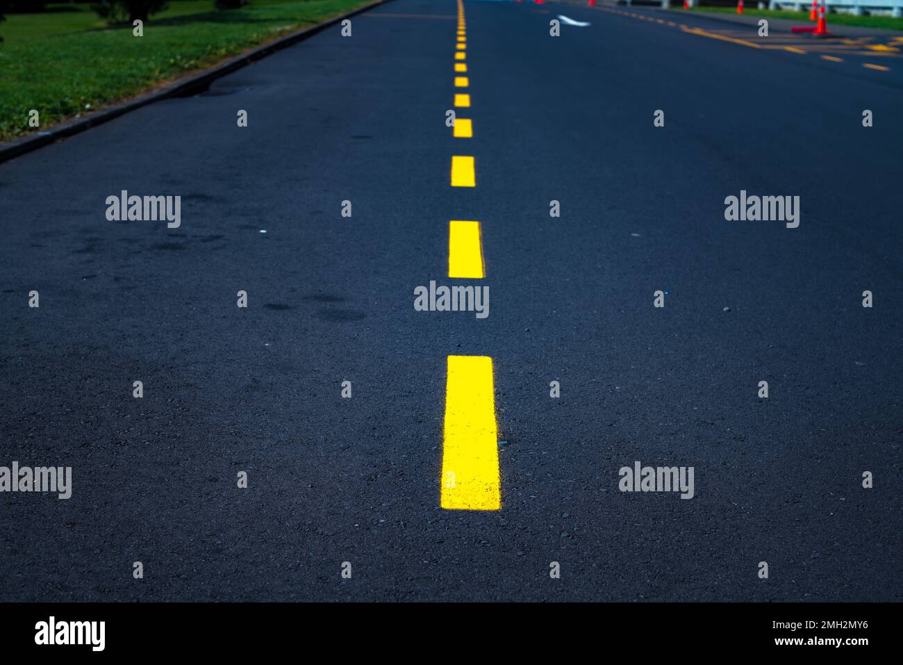 asphalt road with yellow dividing strip Stock Photo - Alamy