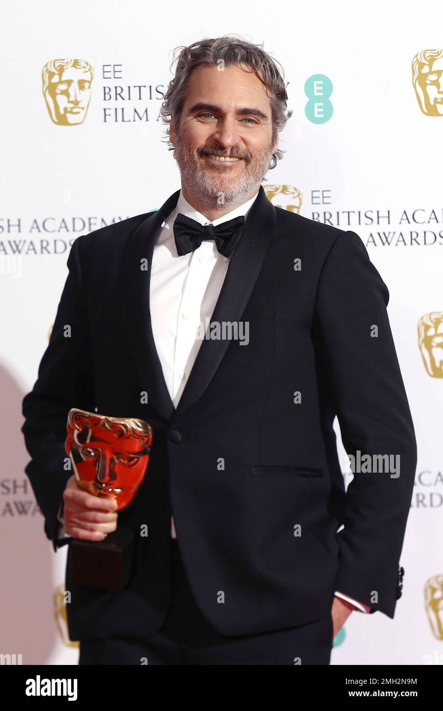 Actor Joaquin Phoenix poses with his award for Best Actor for the film ...