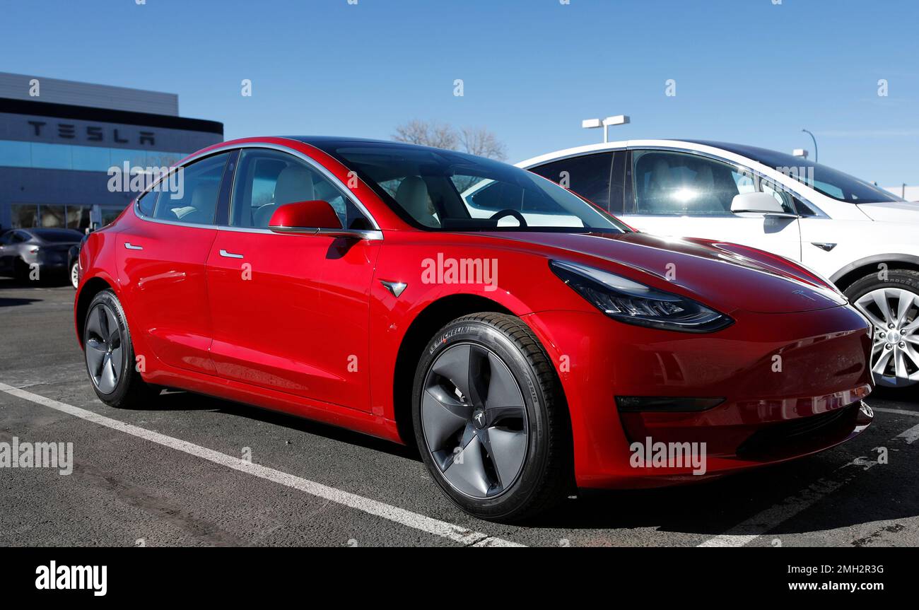 In this Sunday, Feb. 2, 2020, photograph, an unsold 2020 Model 3 sedan ...