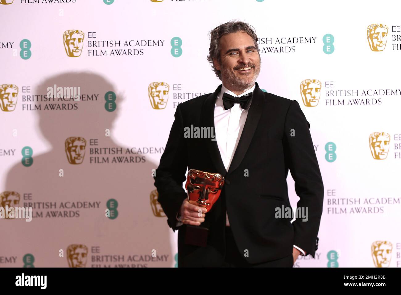 Actor Joaquin Phoenix poses with his award for Best Actor for the film ...