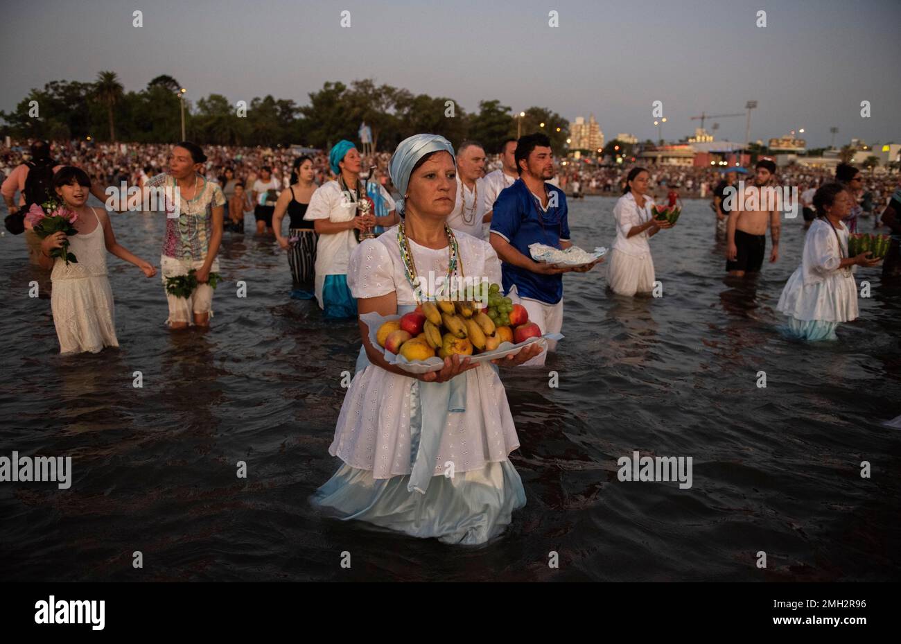 A woman enters the sea with an offering for the African sea goddess ...