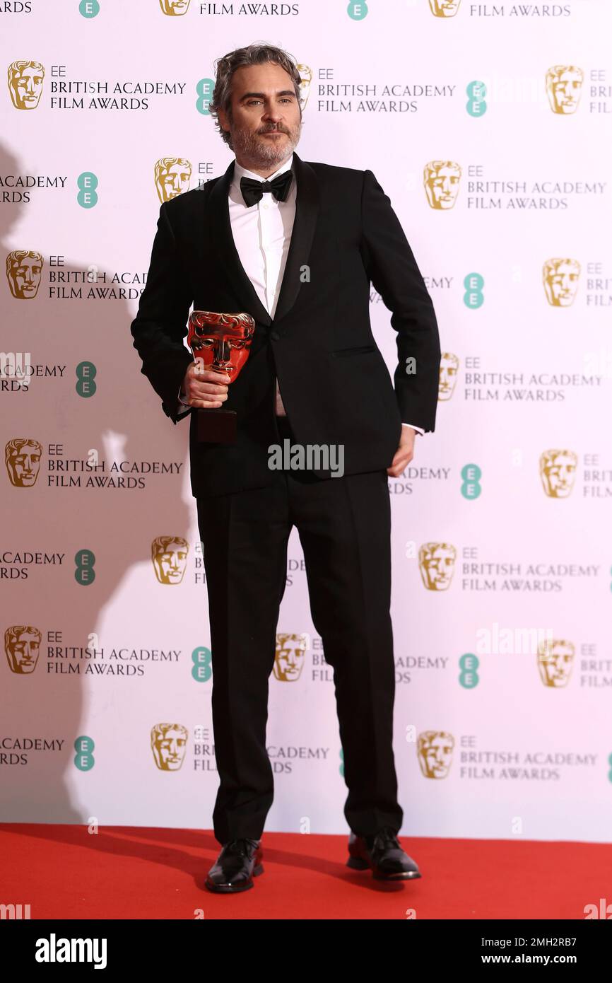 Actor Joaquin Phoenix poses with his award for Best Actor for the film ...