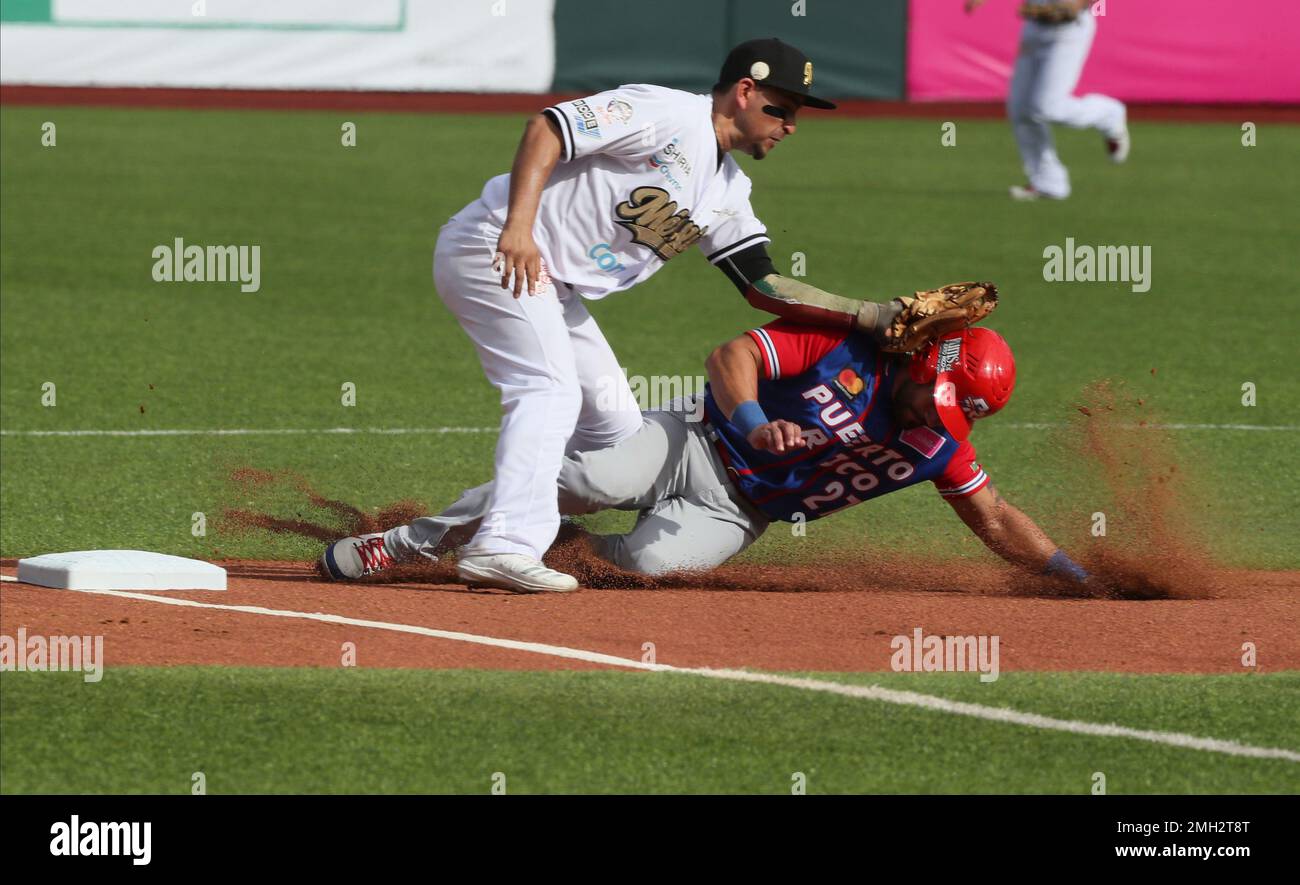 Puerto Rico's Raymond Fuentes, right, is tagged out in third dase by ...