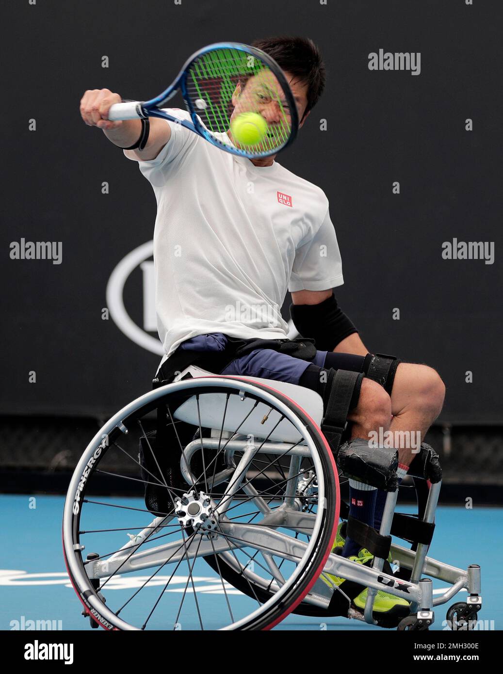 Japan's Shingo Kunieda makes a backhand return to Britain's Gordon Reid ...