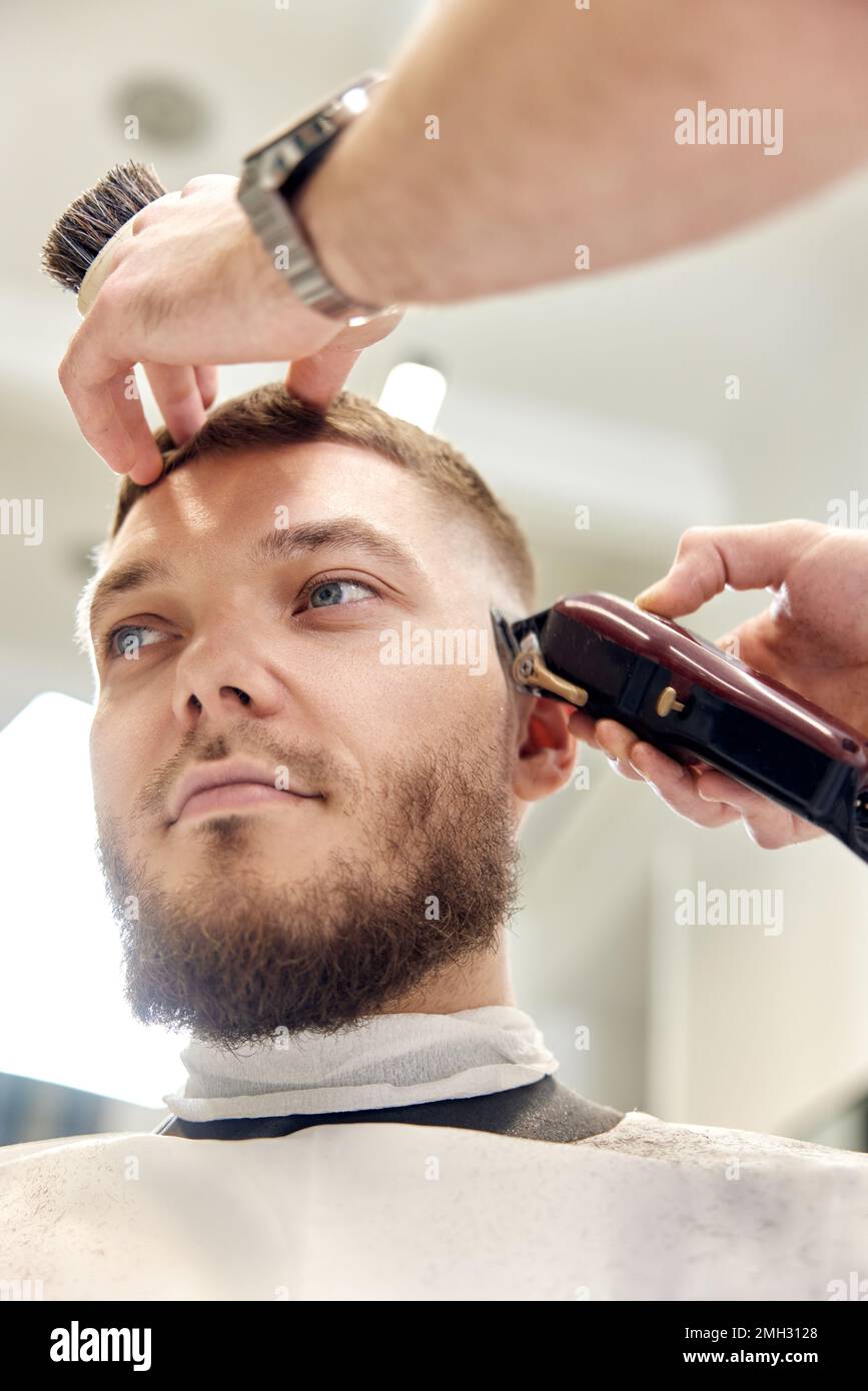 Barber making hairstyle confident hi-res stock photography and images ...
