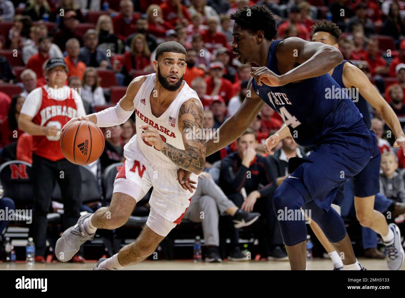 Nebraska's Haanif Cheatham, left, drives to the basket against Penn ...