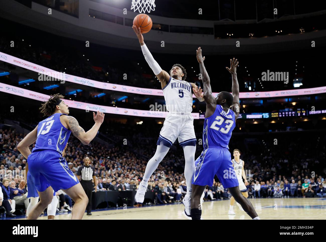 Villanova's Justin Moore (5) goes up for a shot between Creighton's ...