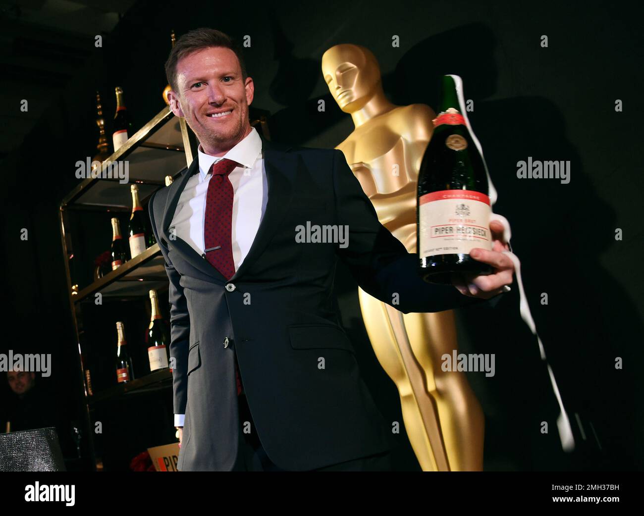 Rare Champagne brand ambassador Kyle Kaplan holds up a bottle of Piper ...