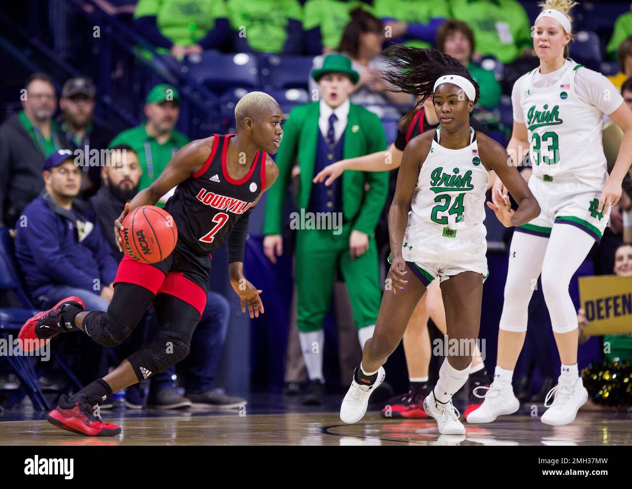 Louisville's Yacine Diop (2) drives in next to Notre Dame's Destinee ...