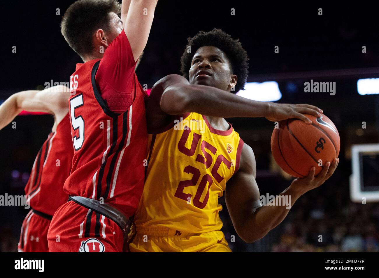 Southern California guard Ethan Anderson, right, drives towards the ...