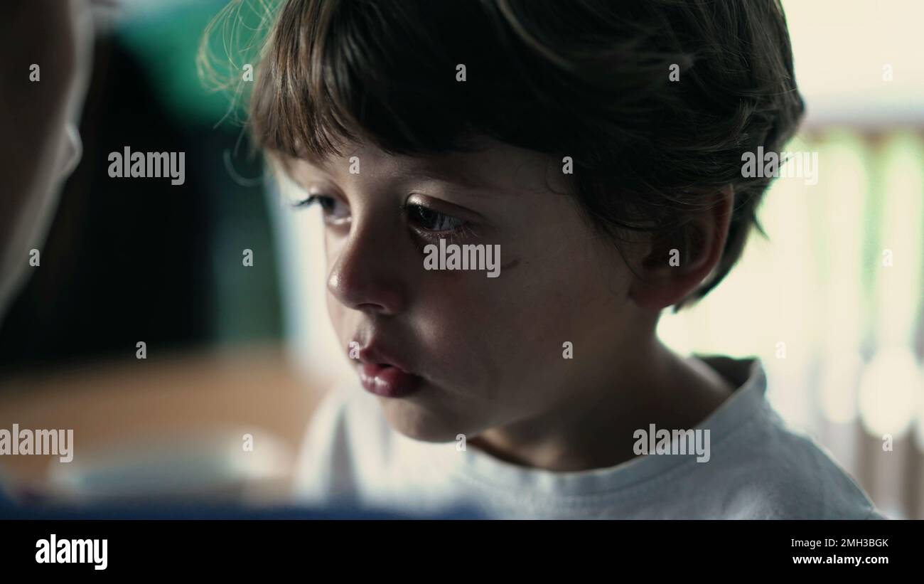 Candid tearful small boy listening to mother scold him for misbehaving ... Candid tearful small boy listening to mother scold him for misbehaving ...