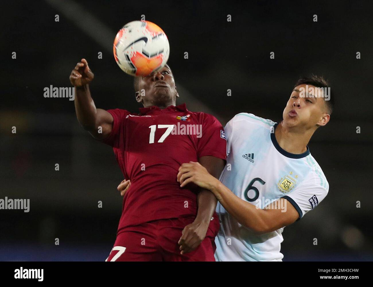 Venezuela's Jan Hurtado, left, fights for the ball with Argentina's ...