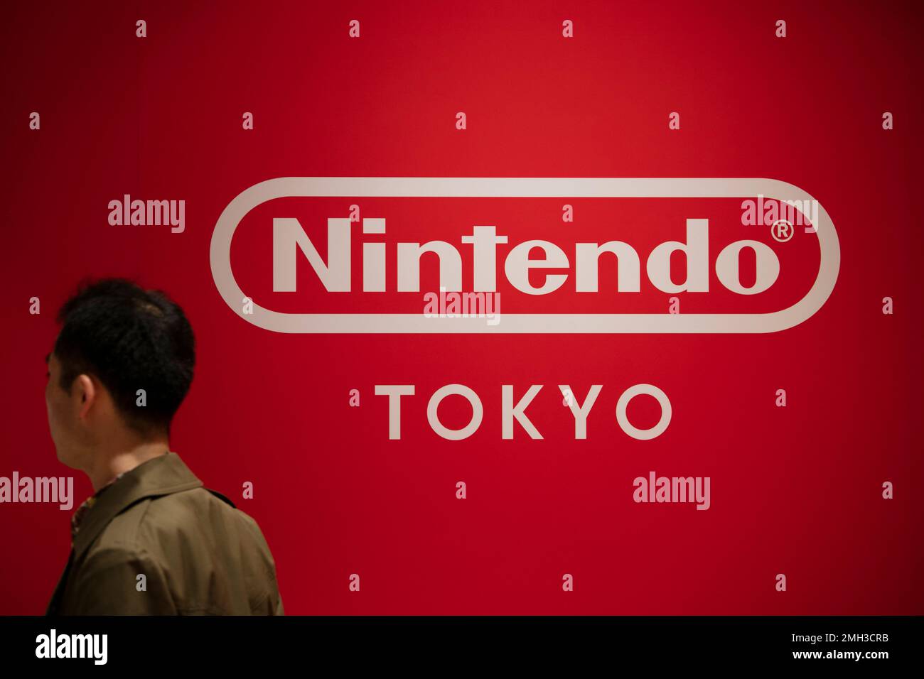 A shopper stands in front of a Nintendo sign at Nintendo's official ...
