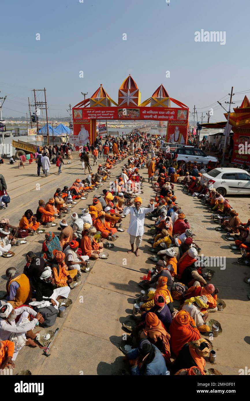 Hindu devotees participate in a community feast at the Sangam, the ...