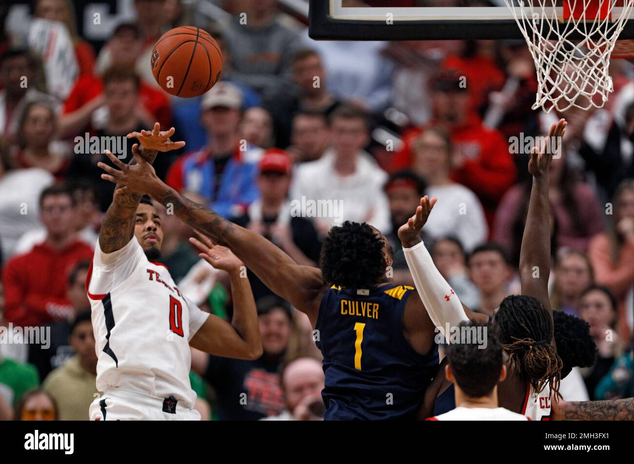 Texas Tech's Kyler Edwards (0) blocks the shot by West Virginia's Derek ...