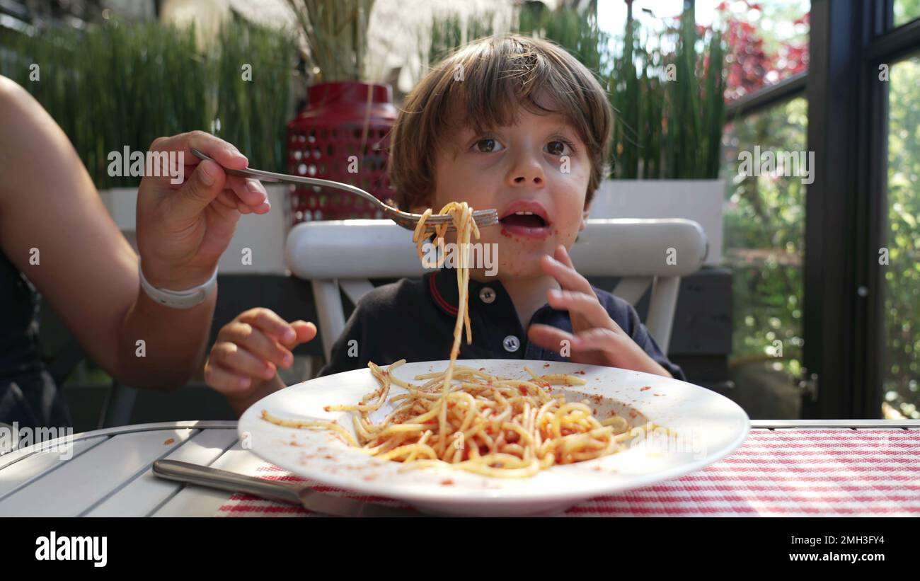 Child rejecting food. Kid not wanting to eat spaghetti with red sauce ...