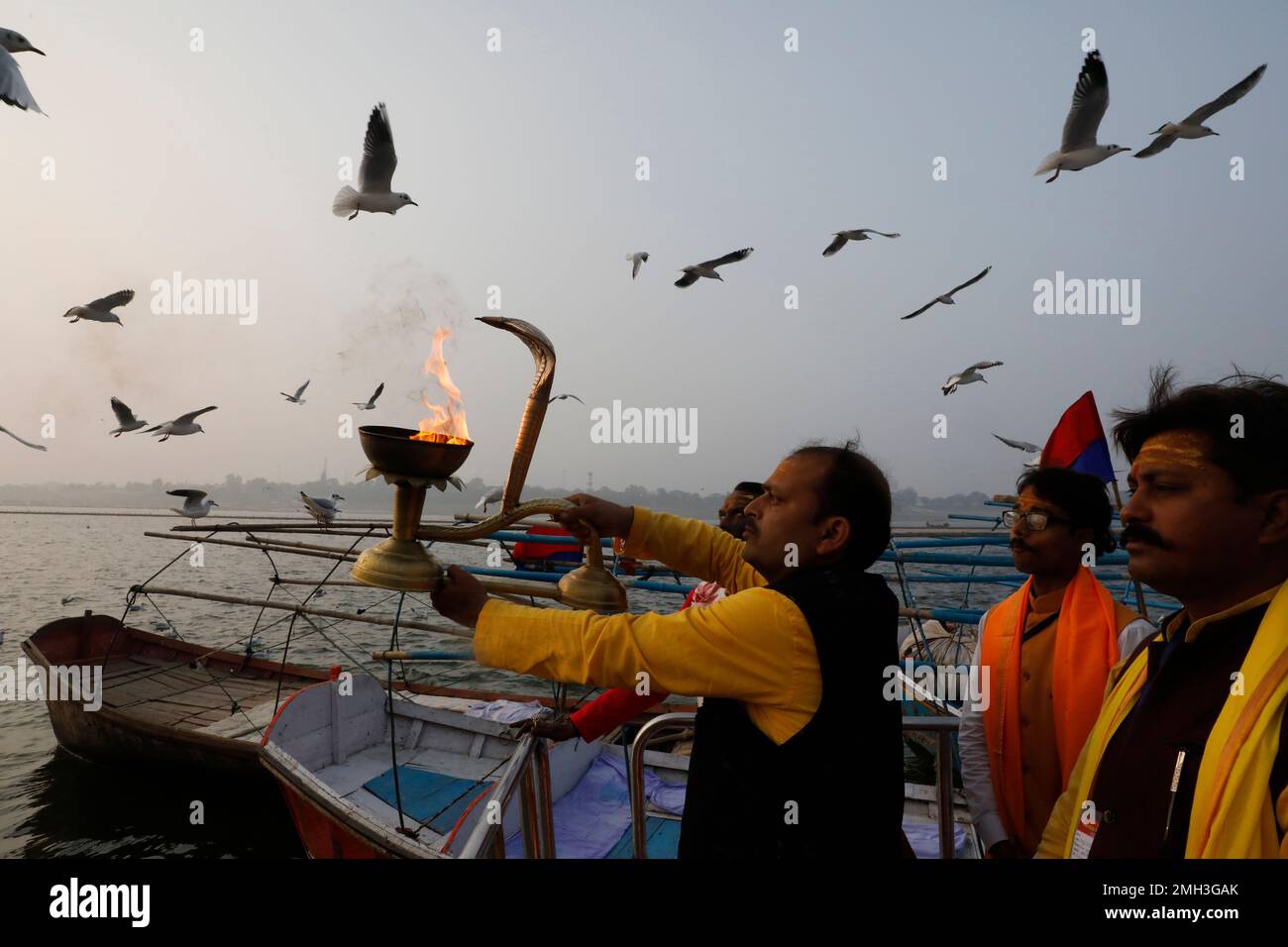 A Hindu priest performs rituals at the Sangam, the confluence of rivers ...
