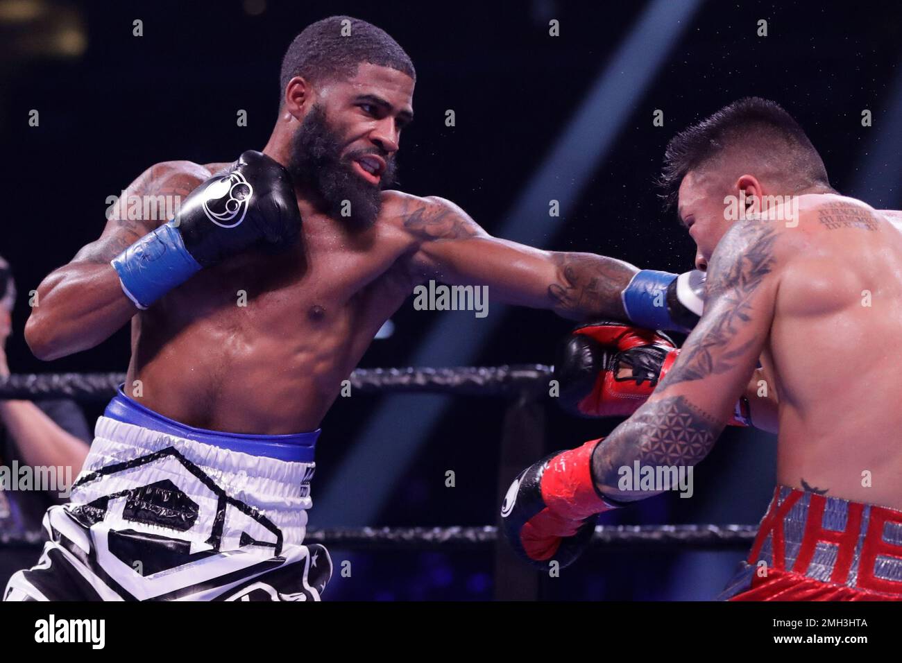 Stephen Fulton, left, punches Ukraine's Arnold Khegai during the ...