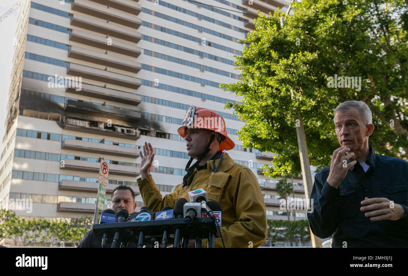 Los Angele Fire Department PIO Capt. Erik Scott, center at podium ...