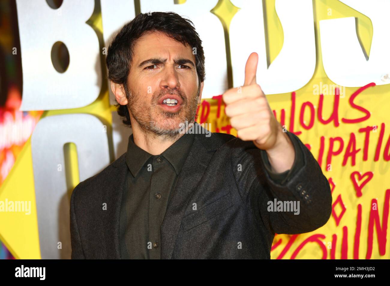 Actor Chris Messina gestures to fans upon arrival at the world premiere ...