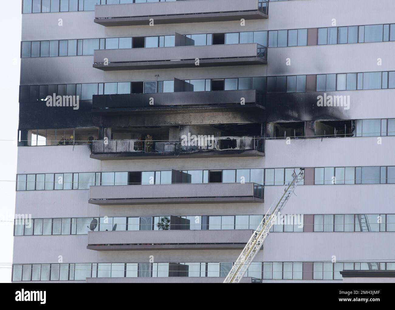 Fire and smoke damage is seen on the exterior of a residential building ...