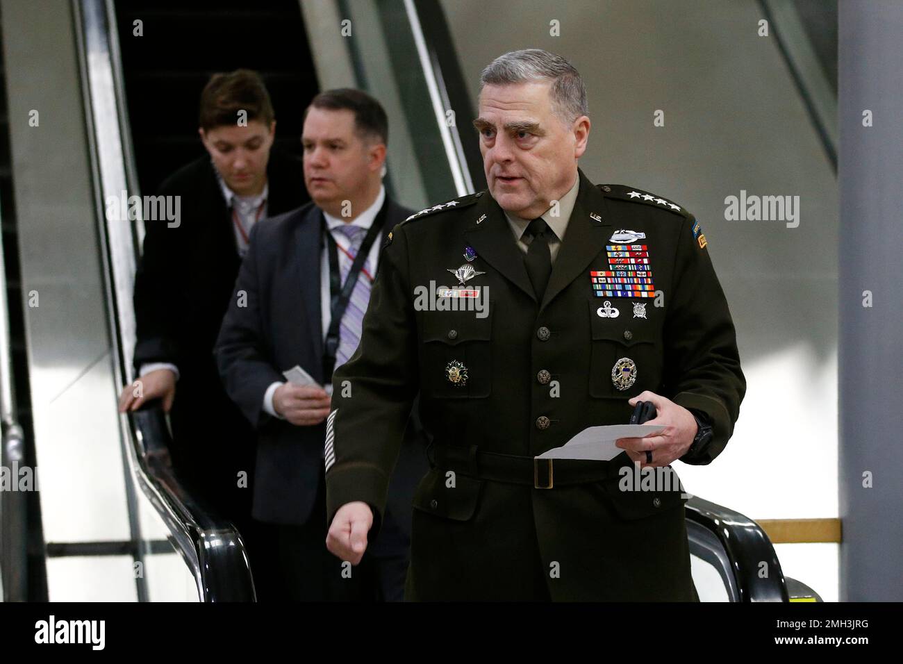 Joint Chiefs of Staff Chairman Gen. Mark Milley, right, walks on ...