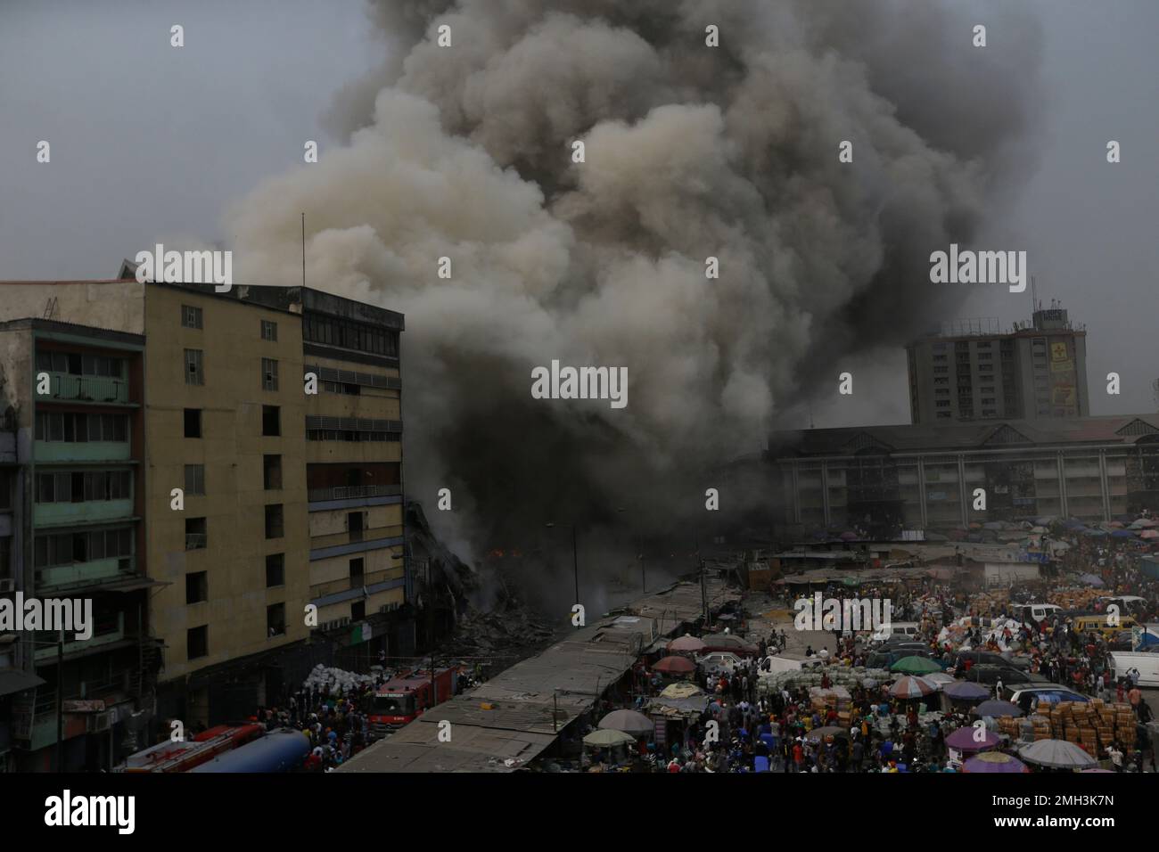 Smoke rises from a fire in downtown Lagos, Nigeria, Wednesday, Jan. 29 ...
