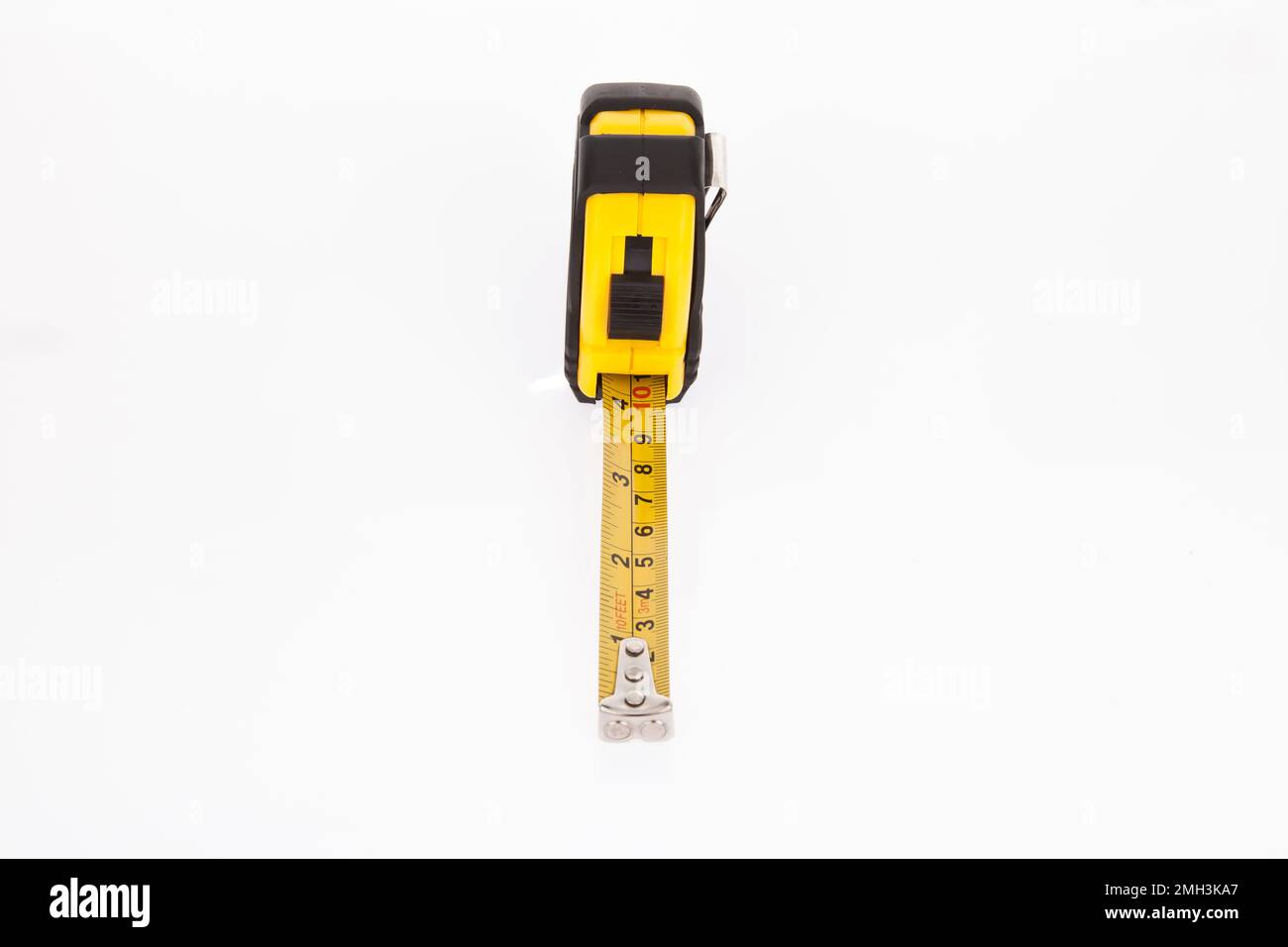 Yellow flexometer with black on white background Stock Photo - Alamy