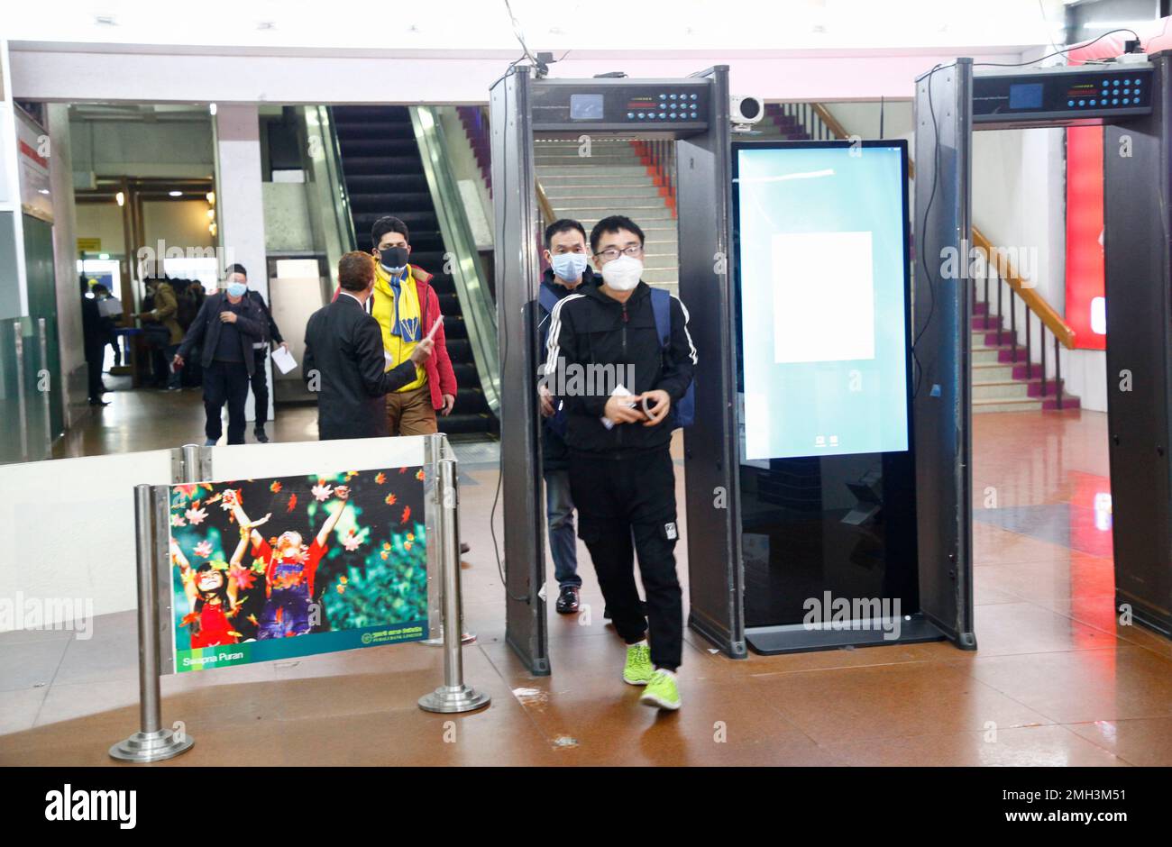 Passenger from Beijing pass through a scanner as they are screened as ...
