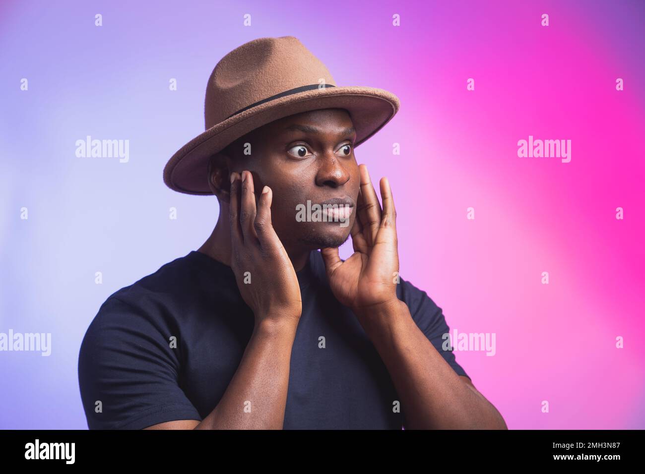 Portrait of excited young African American male screaming in shock and ...
