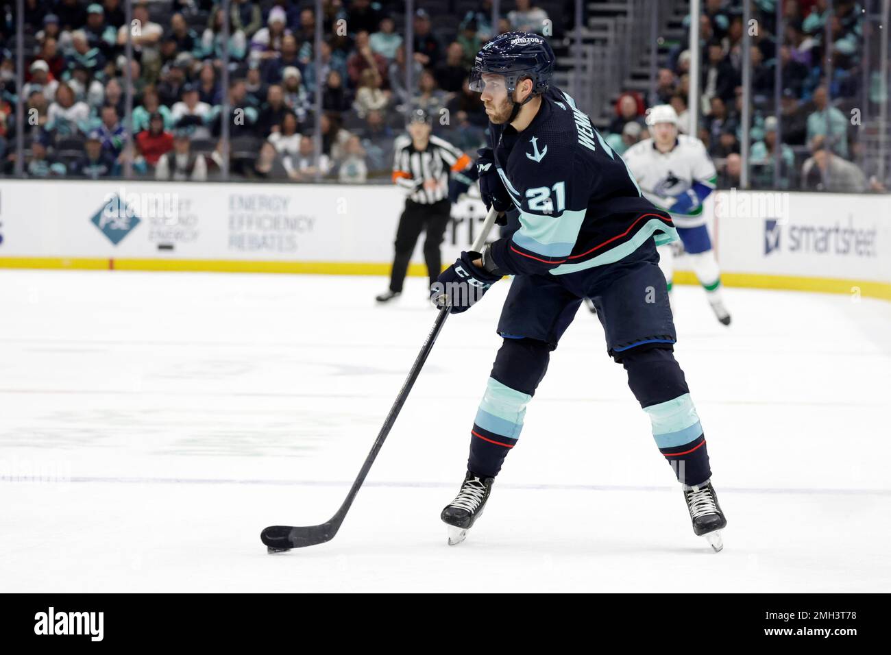 Seattle Kraken center Alex Wennberg (21) skates with the puck against ...