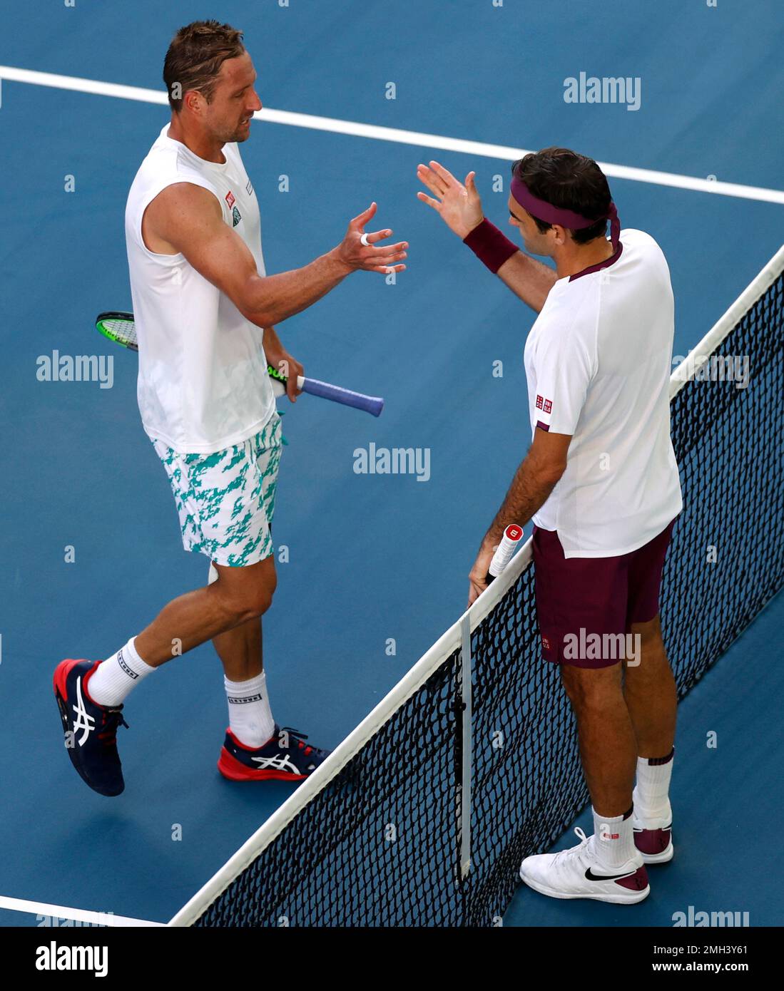 Switzerland's Roger Federer, right, is congratulated by Tennys Sandgren ...