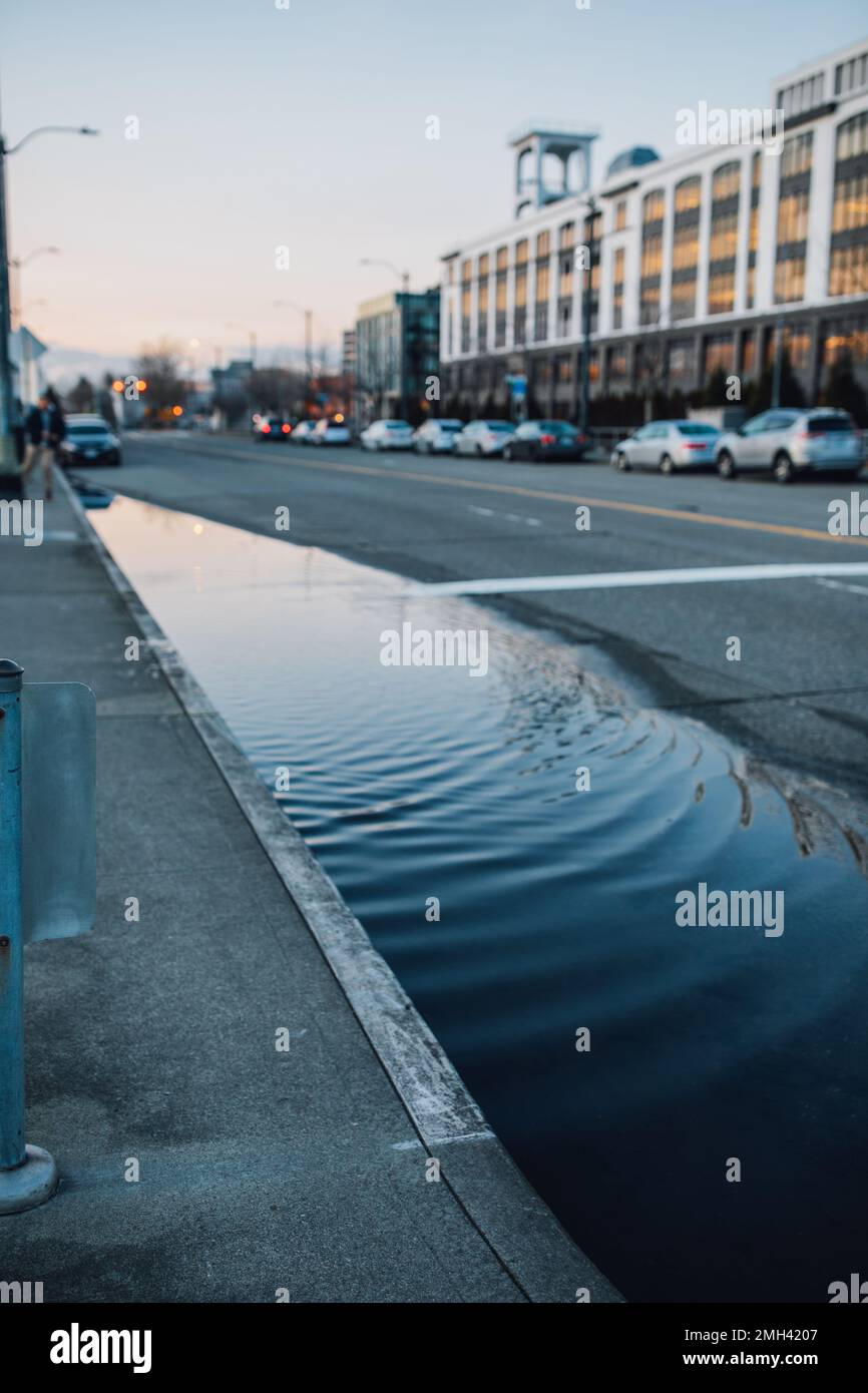 long puddle along street, sidewalk on waterfront street in Seattle ...