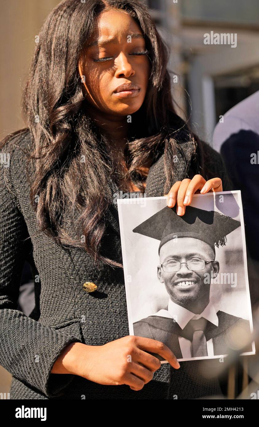 Zipporah Kuria, of London, holds a photo of her deceased father Joseph ...