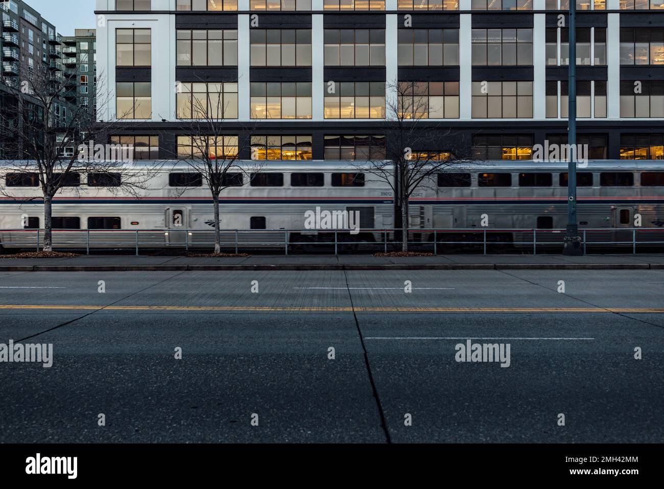 Amtrak passenger train passing through downtown Seattle waterfront ...