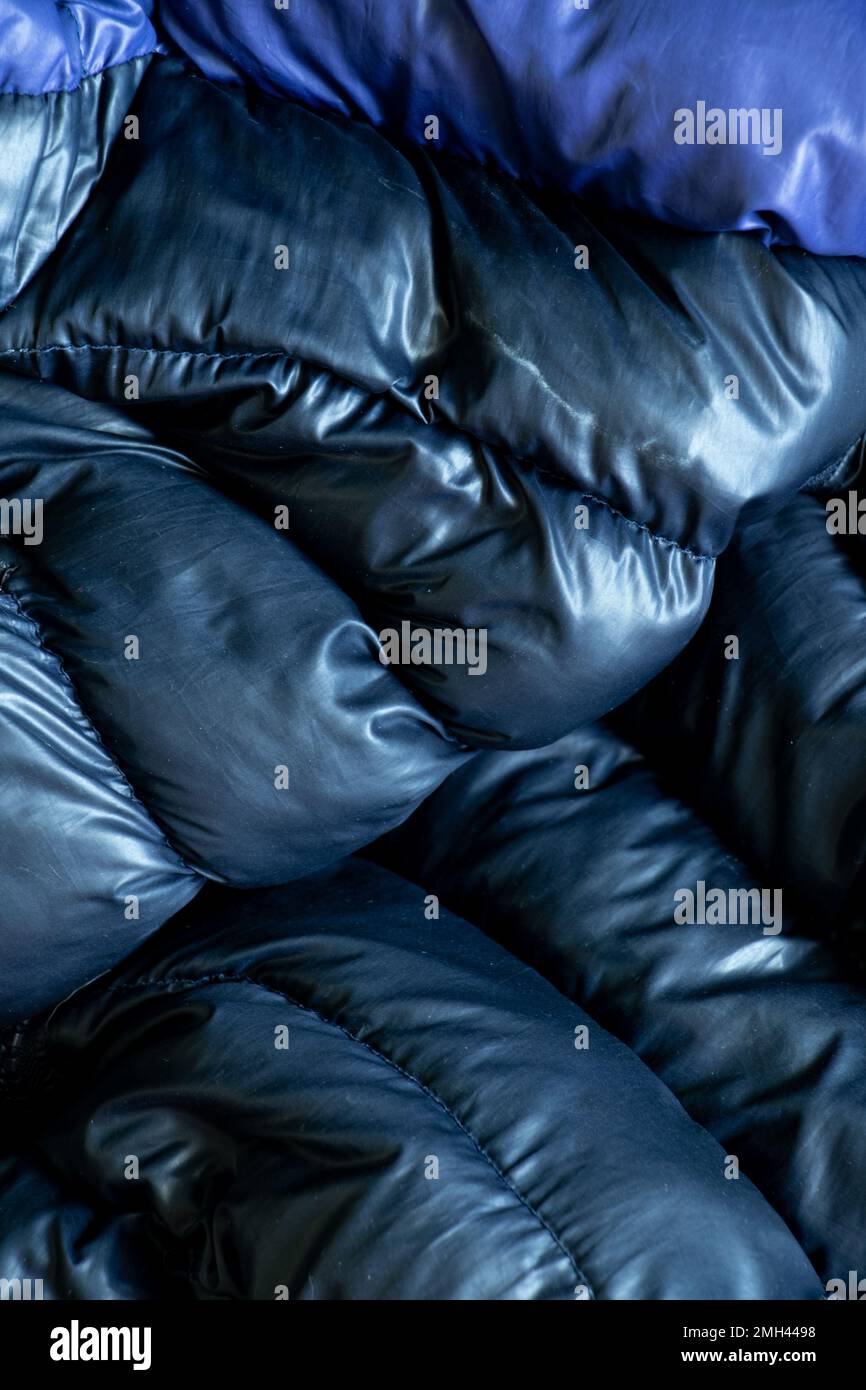 black puffed men's winter jacket as background, down jacket close-up ...