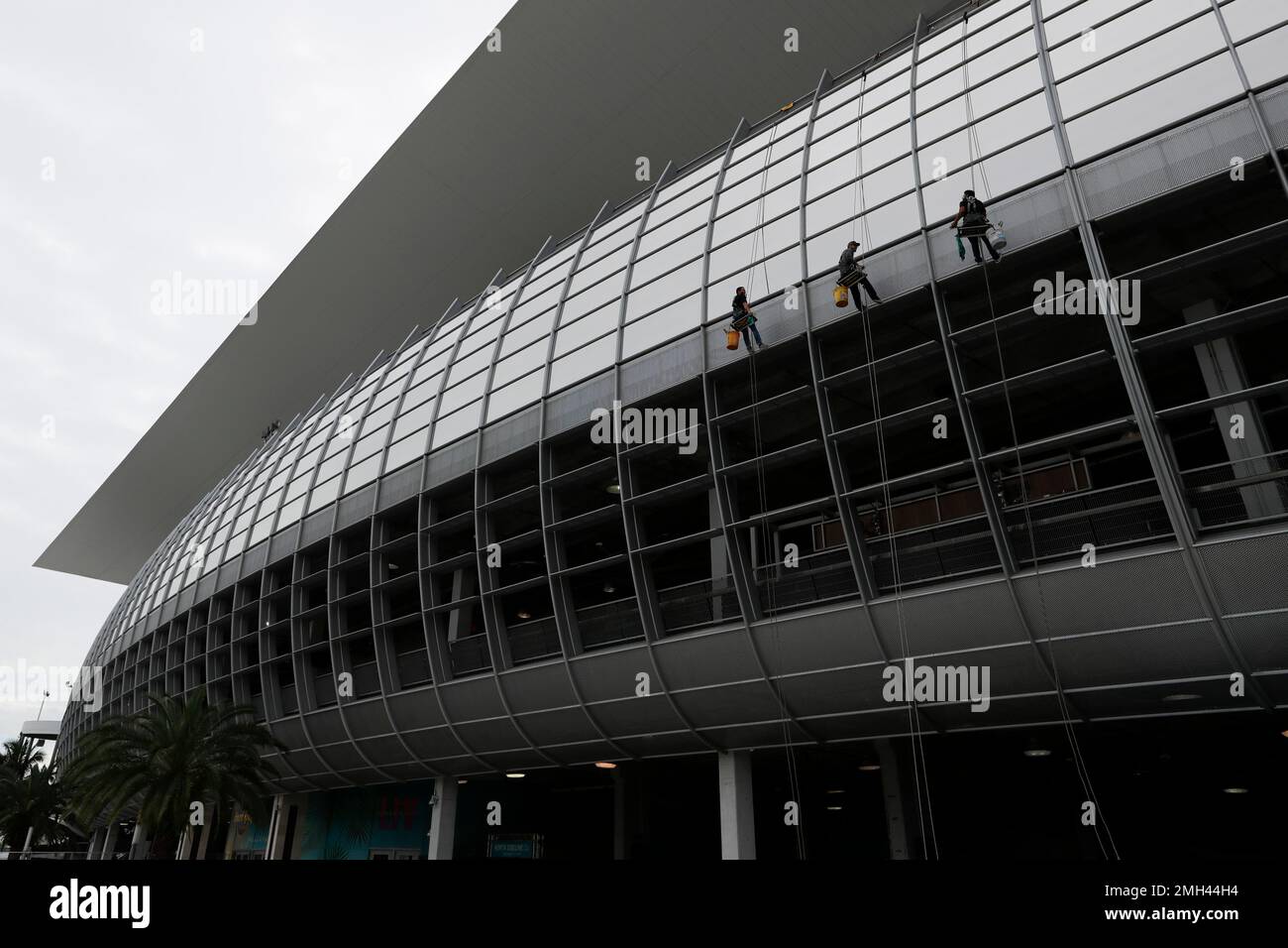 Workers wash windows outside of the Hard Rock Stadium Monday, Jan. 27 ...