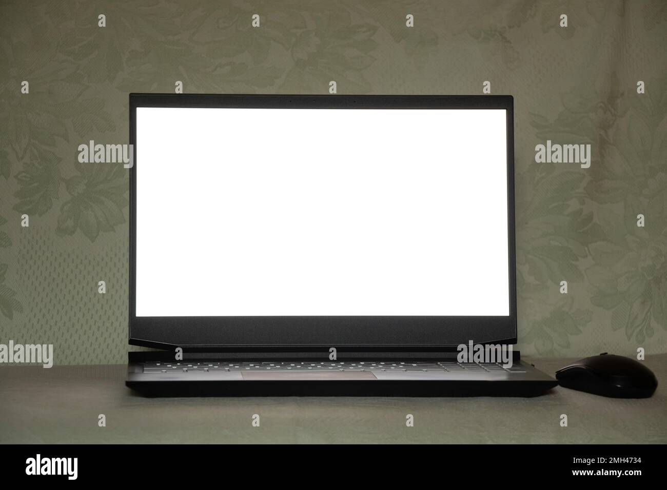 black laptop with white screen stands on the kitchen on the table at ...